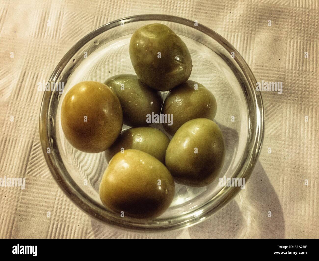 Little dish of large green olives Stock Photo - Alamy