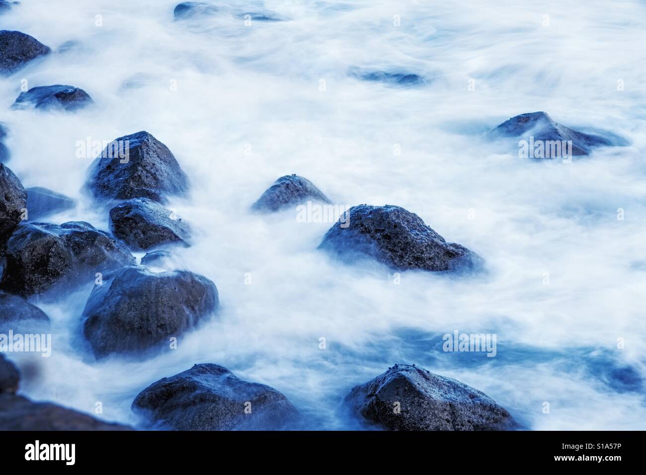 atlantic ocean, volcano rocks in surf on longtime exposure Stock Photo ...