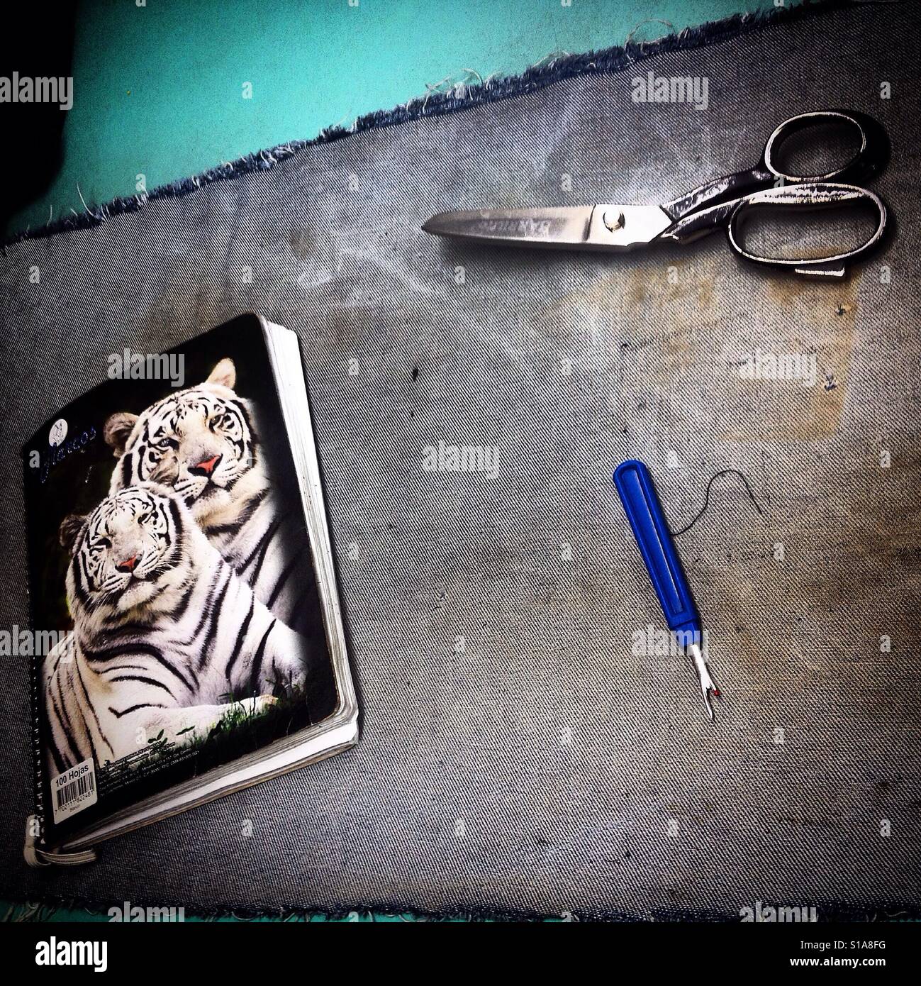 A notebook decorated with a couple of white tigers and scissors in Jose ...