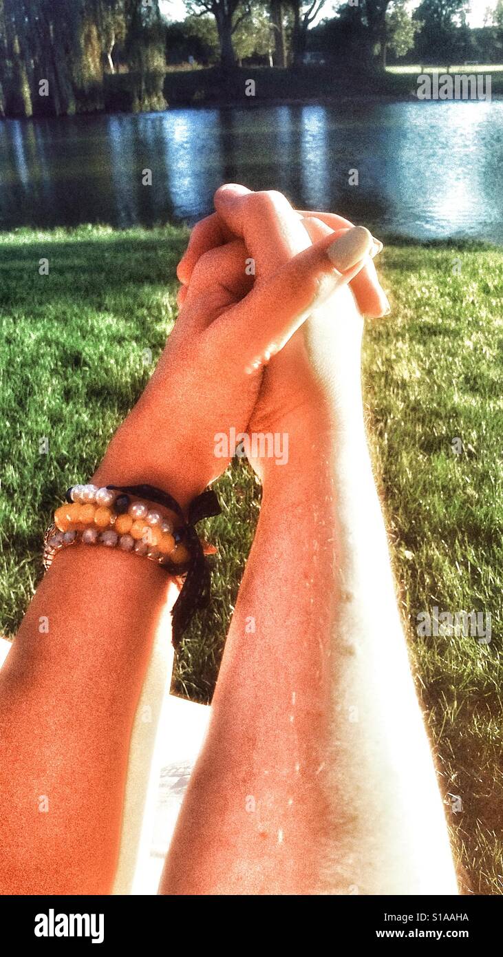 Intertwined arms hi-res stock photography and images - Alamy