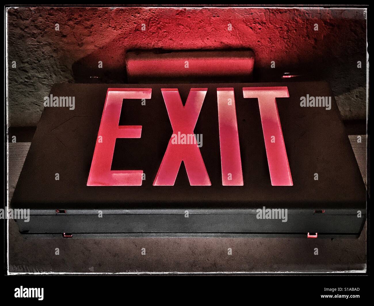 Red-lighted Exit sign Stock Photo - Alamy