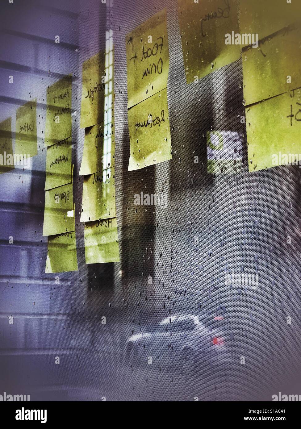 Post-It notes on an office window Stock Photo - Alamy