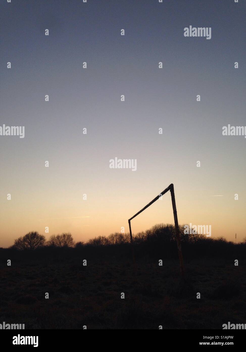 Abandoned goal posts at sunset Stock Photo - Alamy
