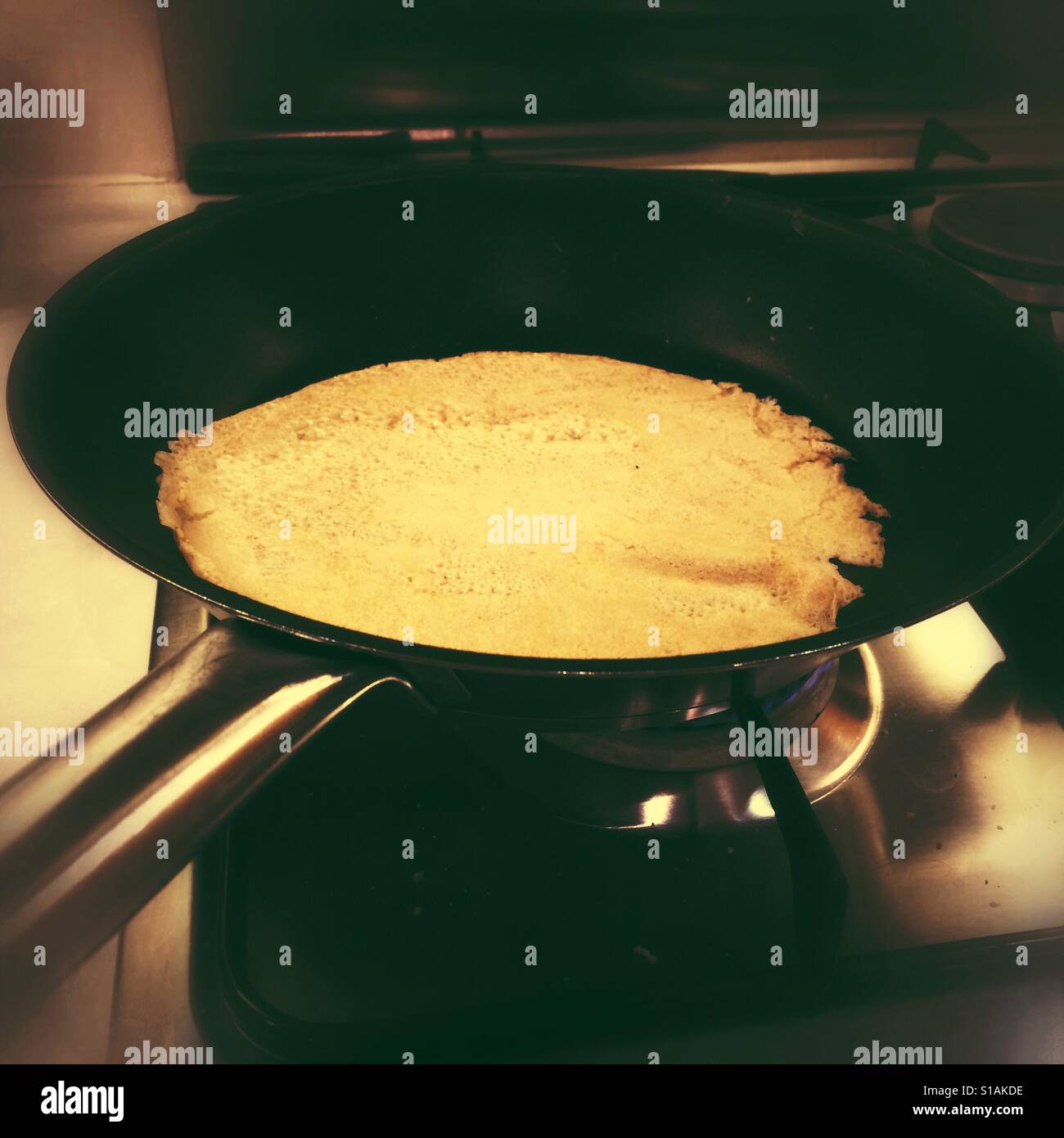 Cooking a pancake in a pan Stock Photo - Alamy