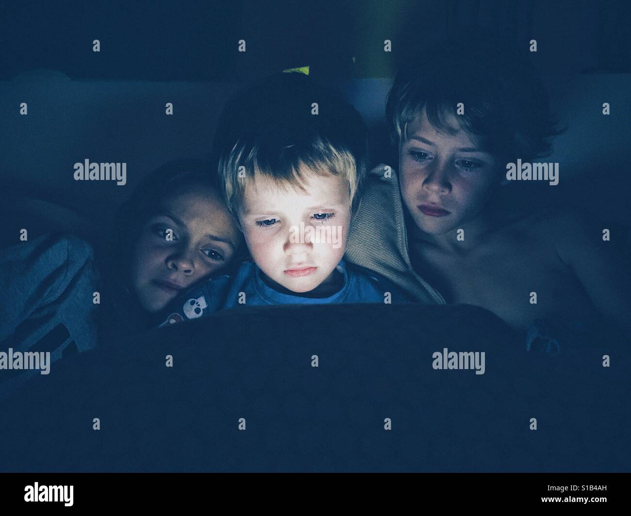Three young children in the night Stock Photo - Alamy