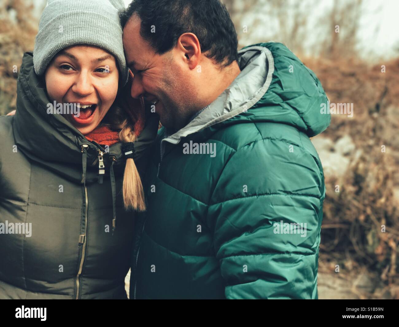 Friends laughing together Stock Photo - Alamy