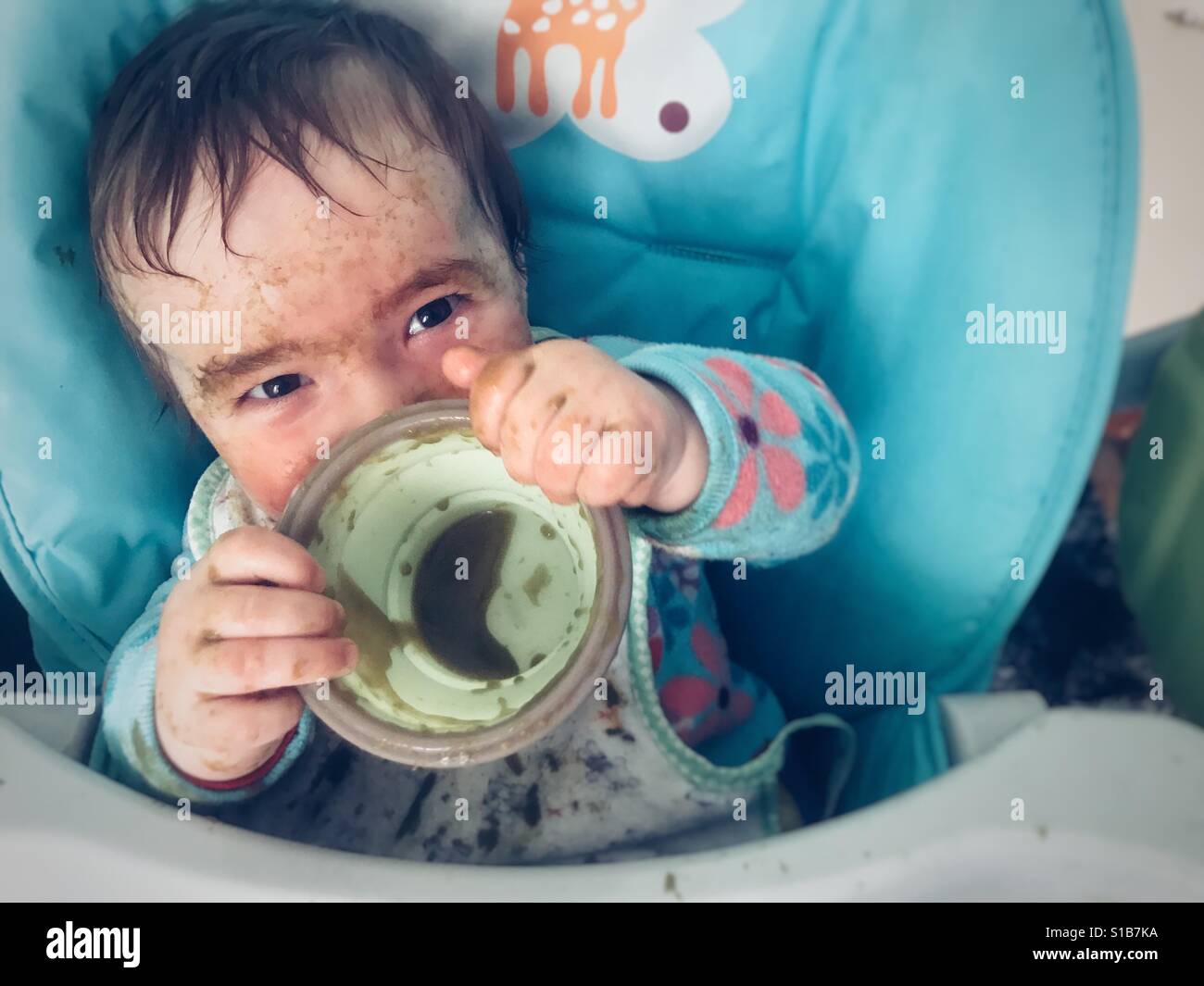 Baby eating messily Stock Photo - Alamy