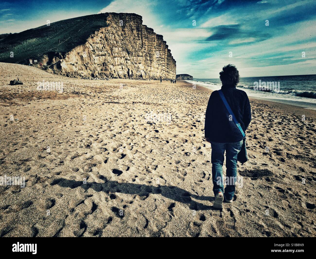 Woman walking on beach, back view Stock Photo - Alamy