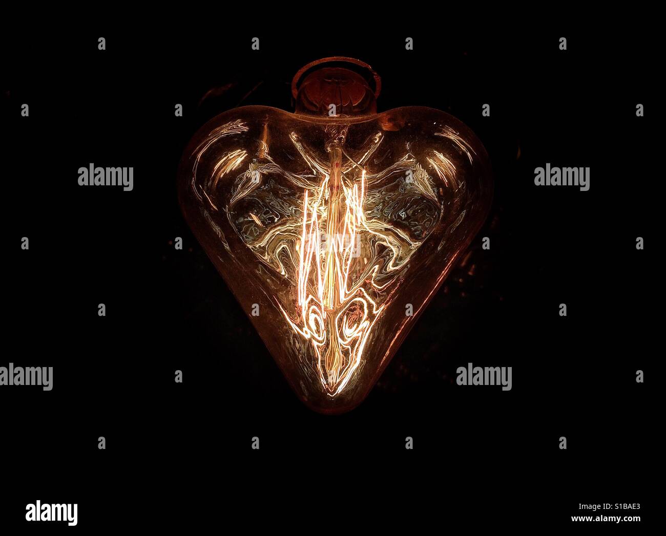 Heart shaped light bulb Stock Photo - Alamy
