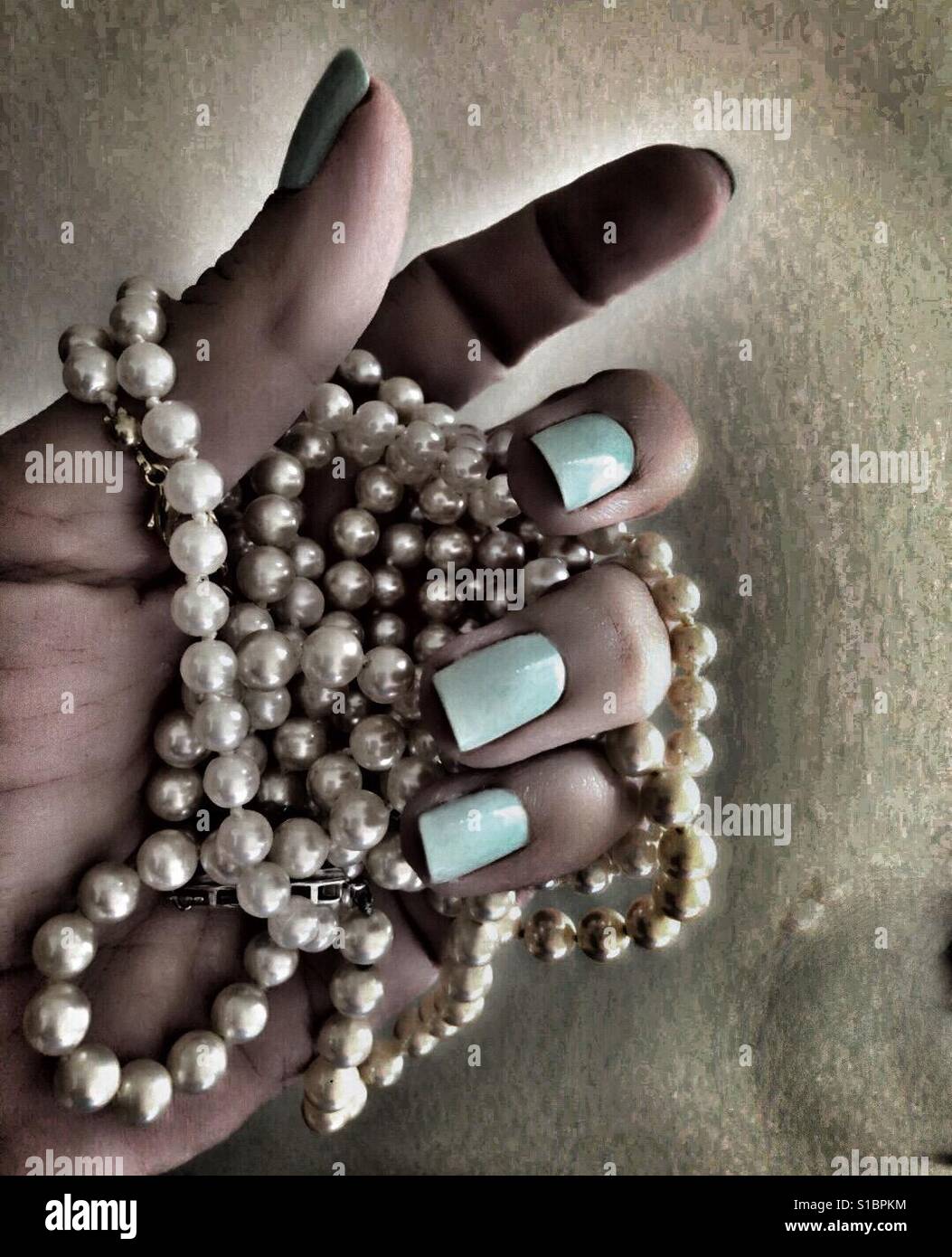 Woman's Hand Holding Strand of Pearls Stock Photo - Alamy