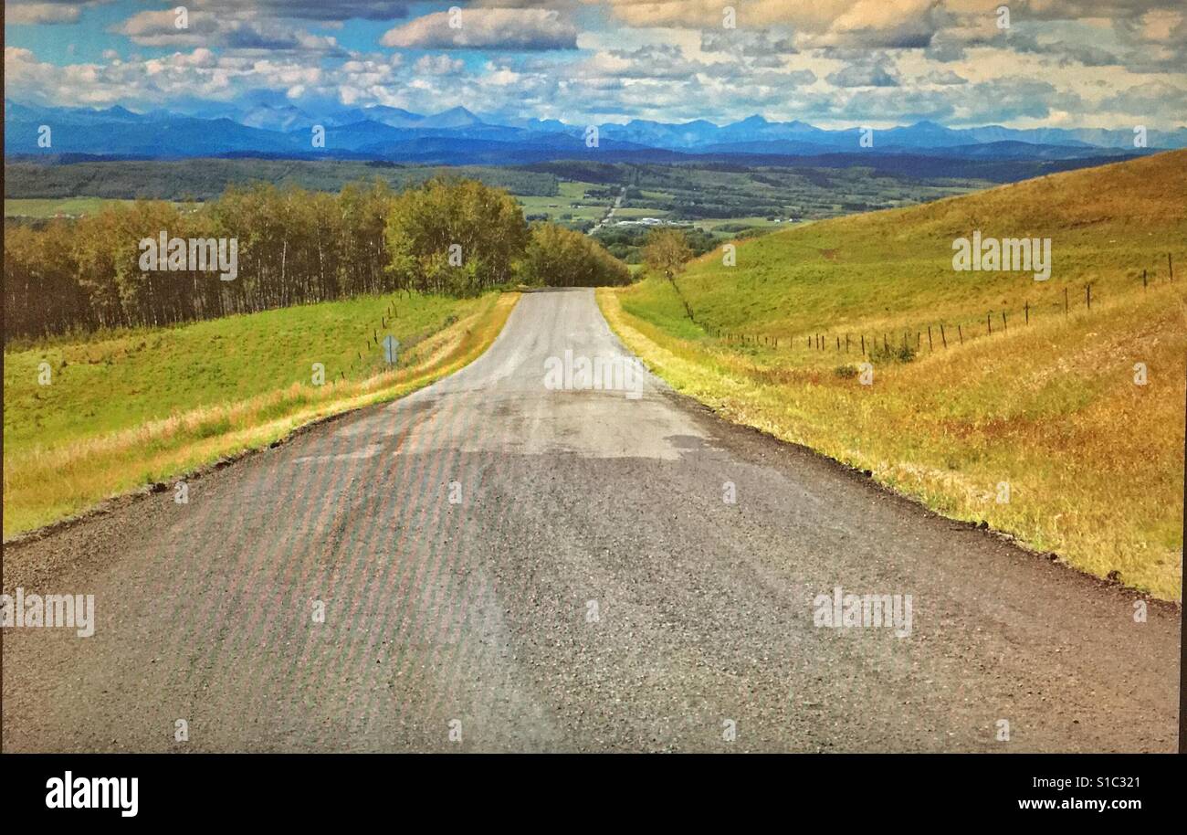 Gravel road and Rocky Mountain view Stock Photo - Alamy
