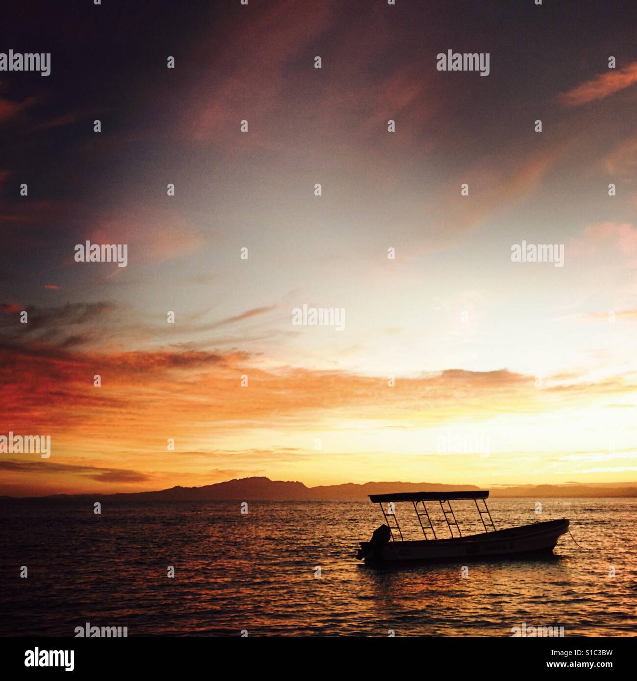 A sunset over Nadi island from Tavarua. Tavarua Island, Fiji Stock ...