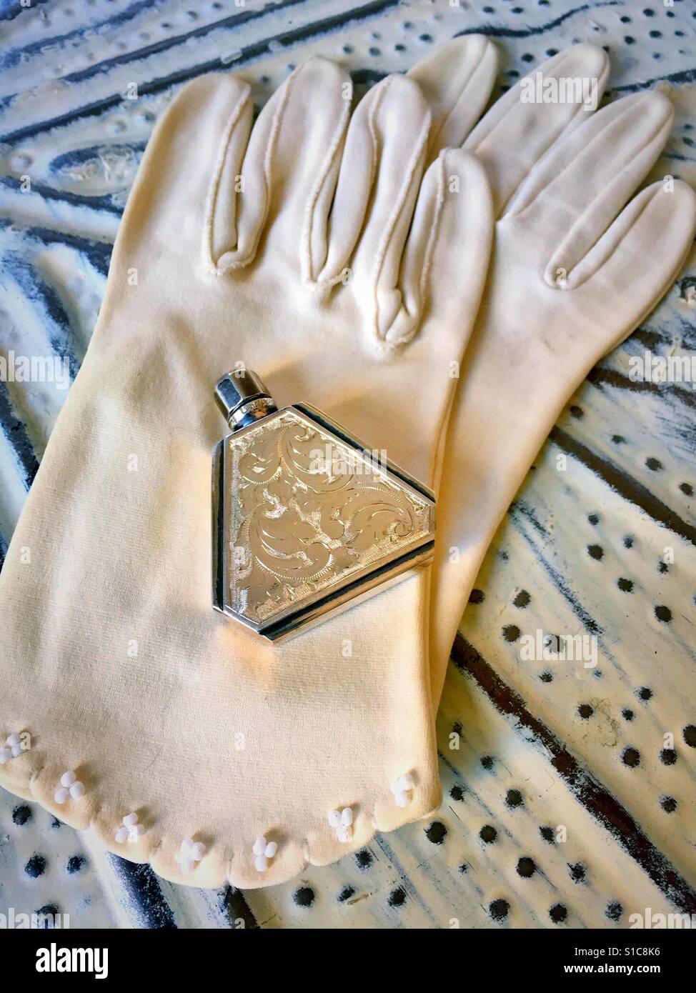 Vintage sterling silver perfume vial on white gloves still life Stock ...