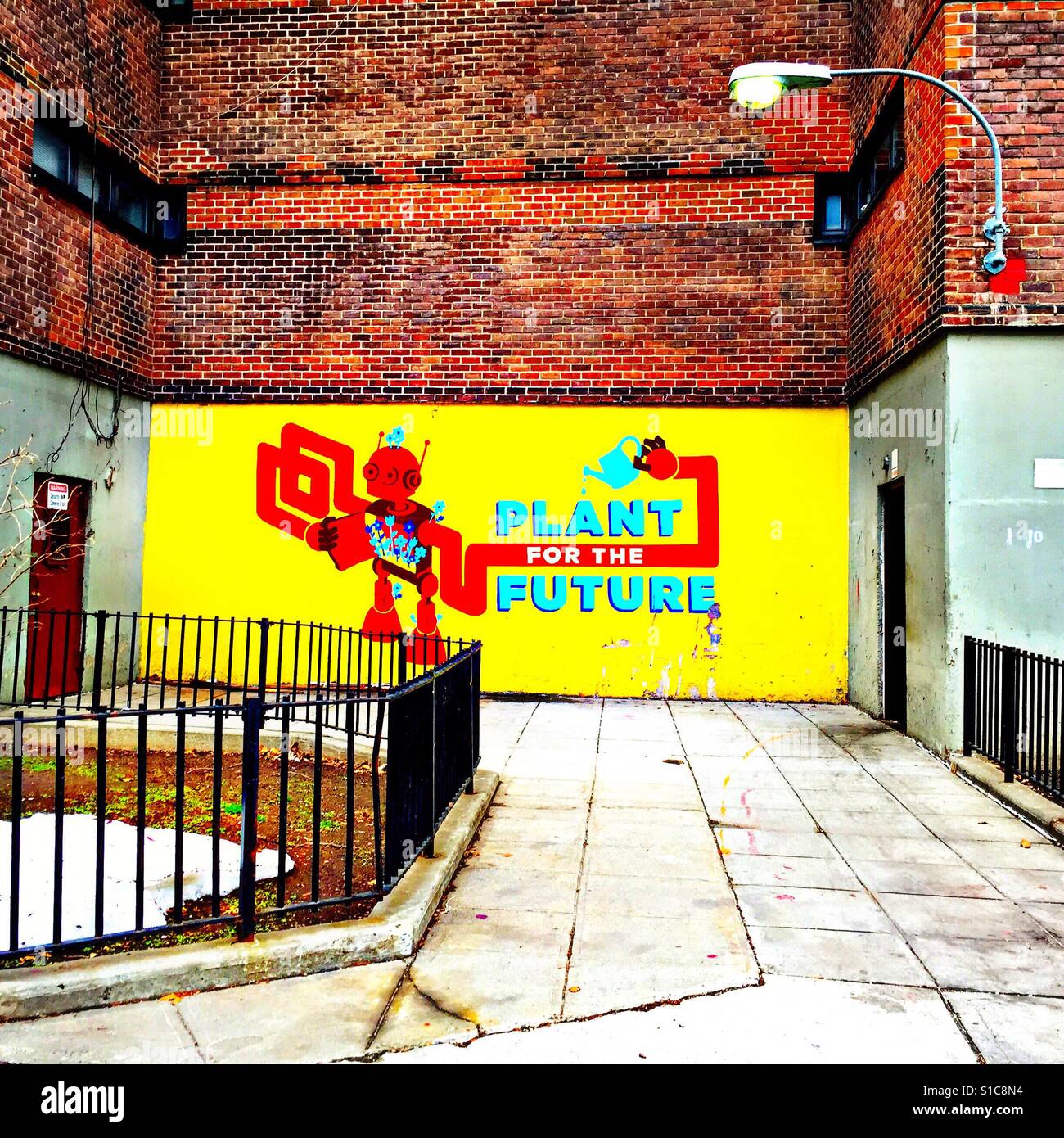 Plant for the future mural on city brick wall Stock Photo - Alamy