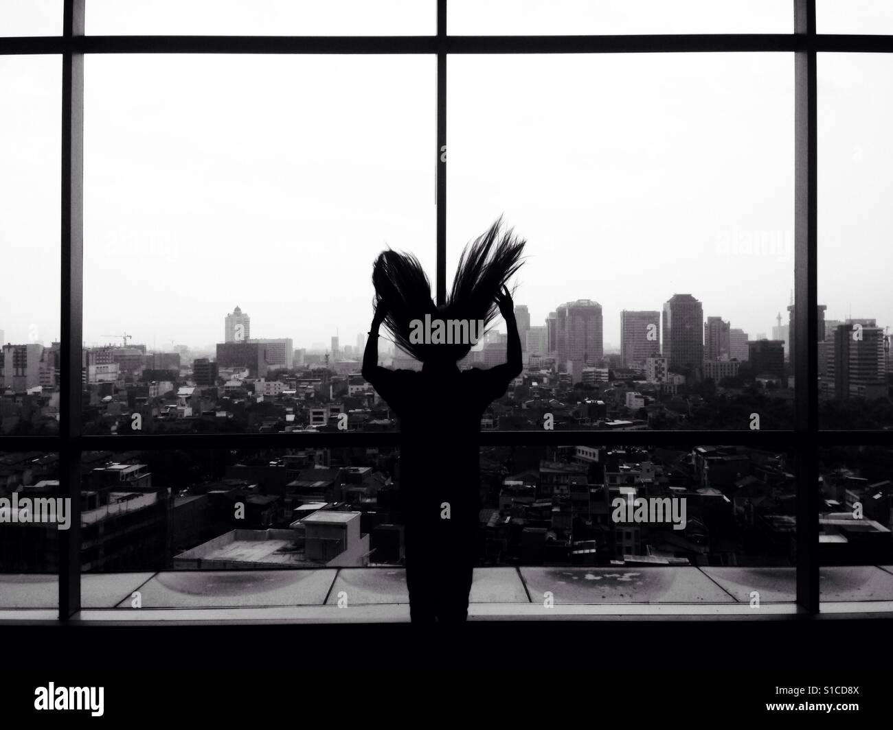 Silhouette of Man Throw His Long Hair with Cityscape Landscape ...