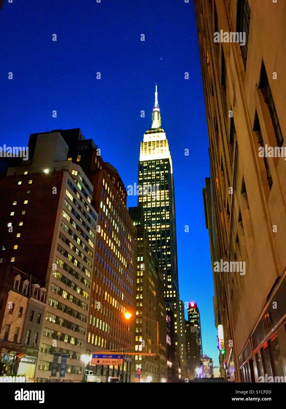 The Empire State building lit in white lights at twilight, NYC, USA ...