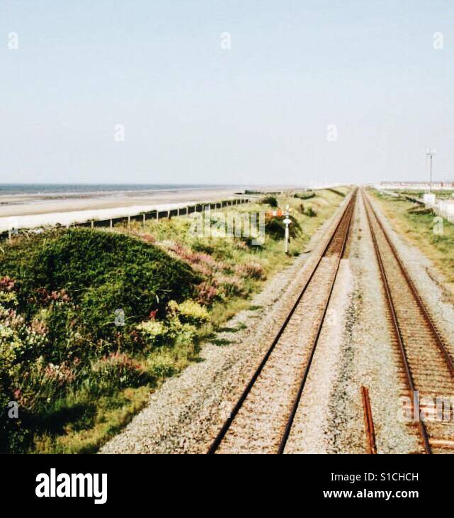 Railway next to beach Stock Photo - Alamy