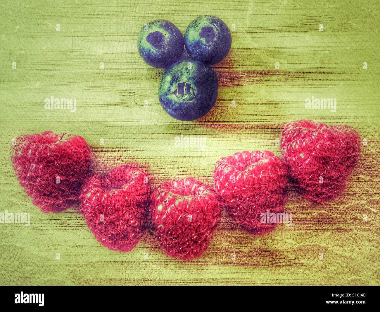 Raspberries and blueberries, smiley face Stock Photo - Alamy