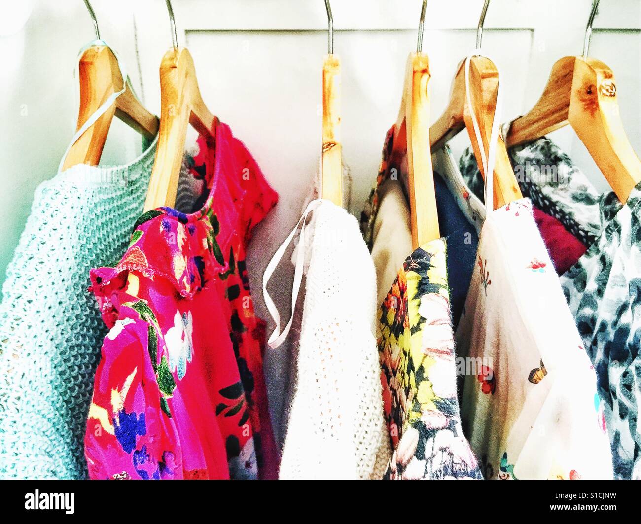 Colourful ladies clothes on hangers Stock Photo - Alamy