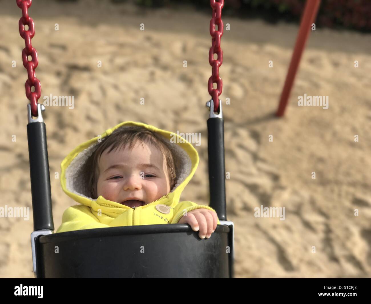 Happy toddler on playground hi-res stock photography and images - Alamy