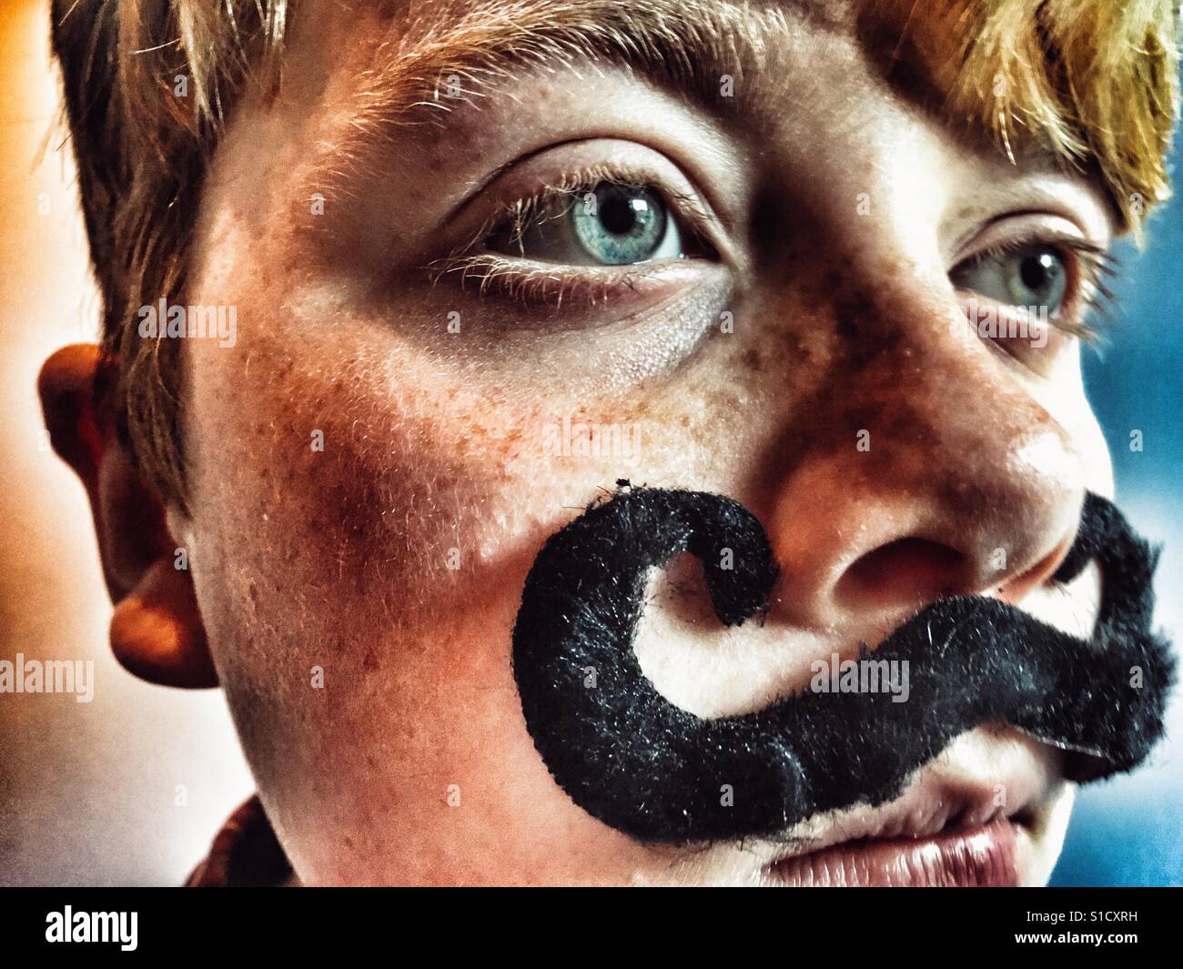 Boy wearing a comedy moustache Stock Photo - Alamy