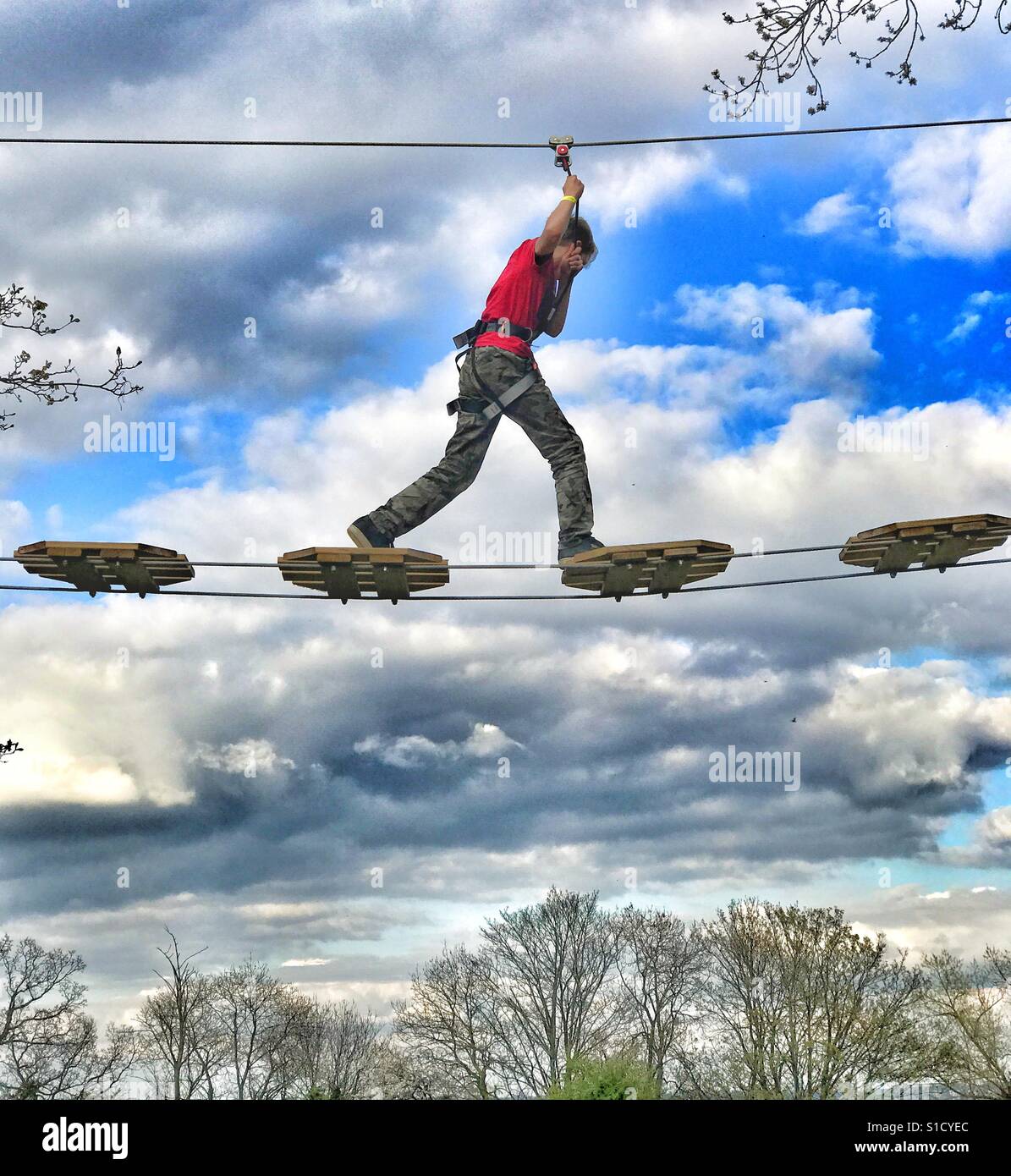 A boy balancing on a Go Ape activity course Stock Photo - Alamy