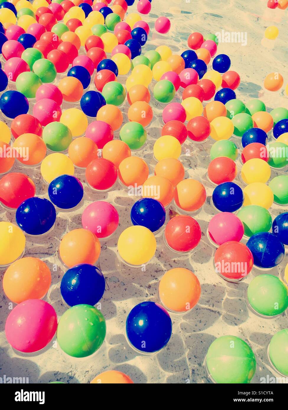 Balls floating on water Stock Photo - Alamy