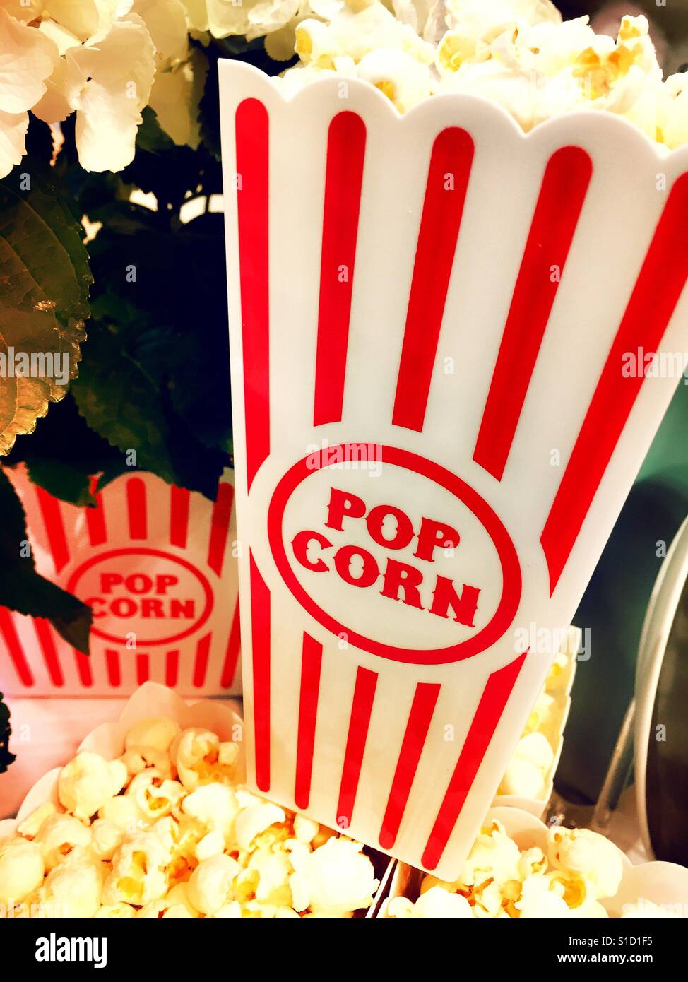 Popcorn box and loose popcorn at the movies, USA Stock Photo - Alamy
