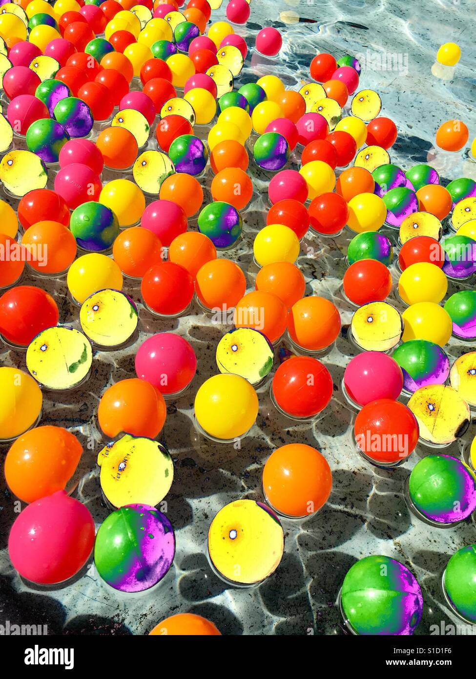 Colorful plastic balls floating on water Stock Photo - Alamy