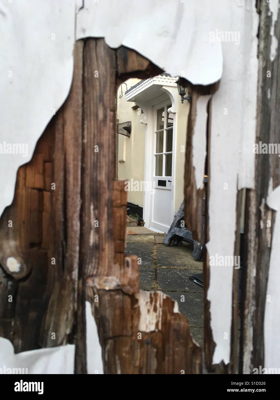 View of a doorway through a rotten wooden gate Stock Photo - Alamy