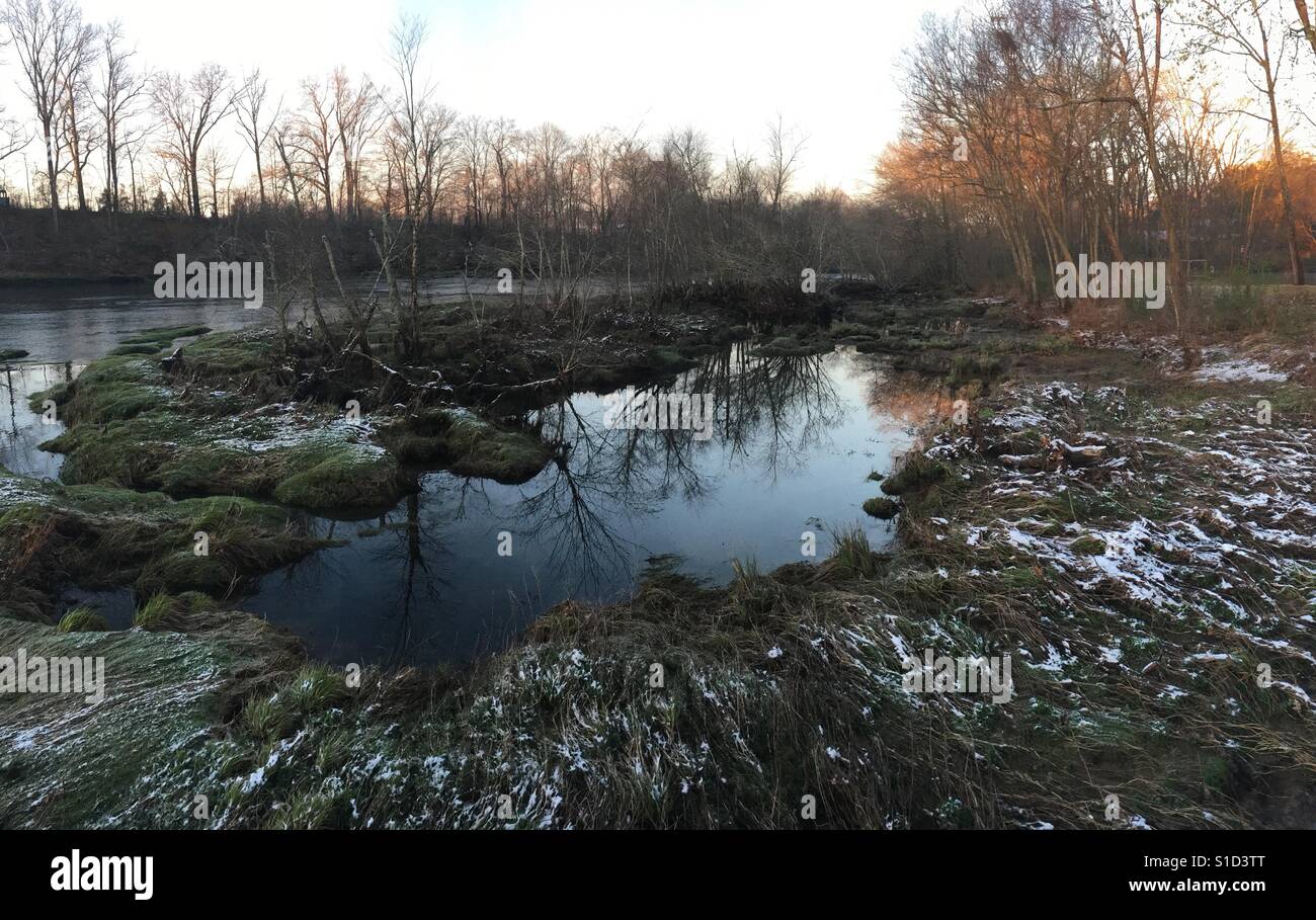 Light snowfall on the banks of the little red river Stock Photo - Alamy