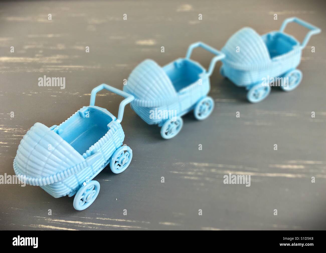 Three blue toy baby carriages in a line Stock Photo - Alamy