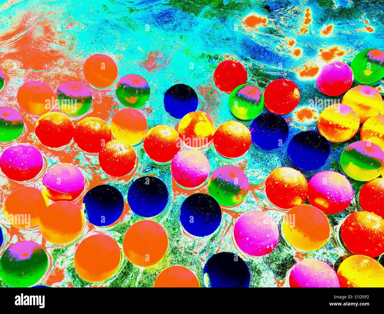 Colorful plastic balls floating on water Stock Photo - Alamy
