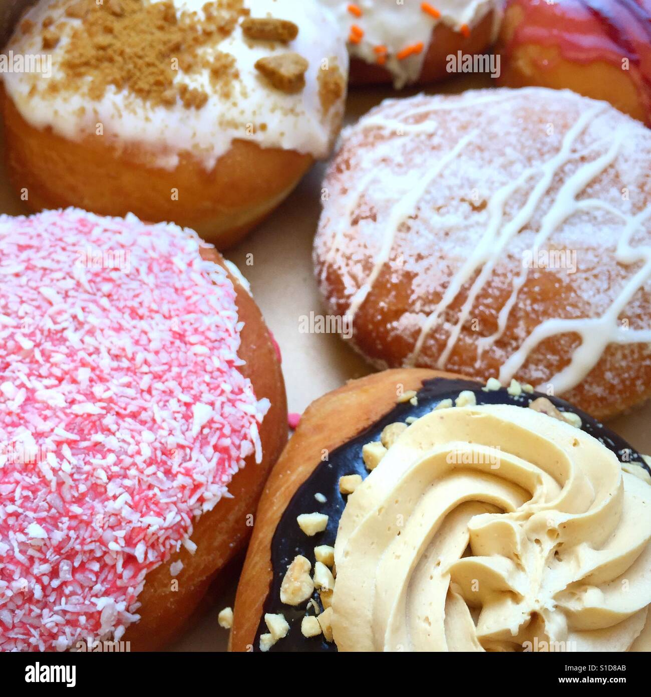 A closeup photo of fancy filled iced donuts Stock Photo - Alamy