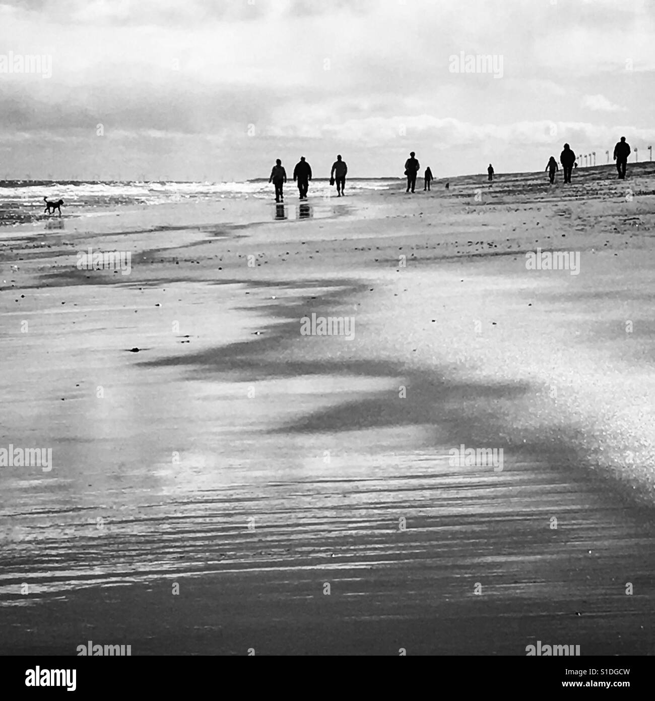 People walking along the beach Stock Photo - Alamy
