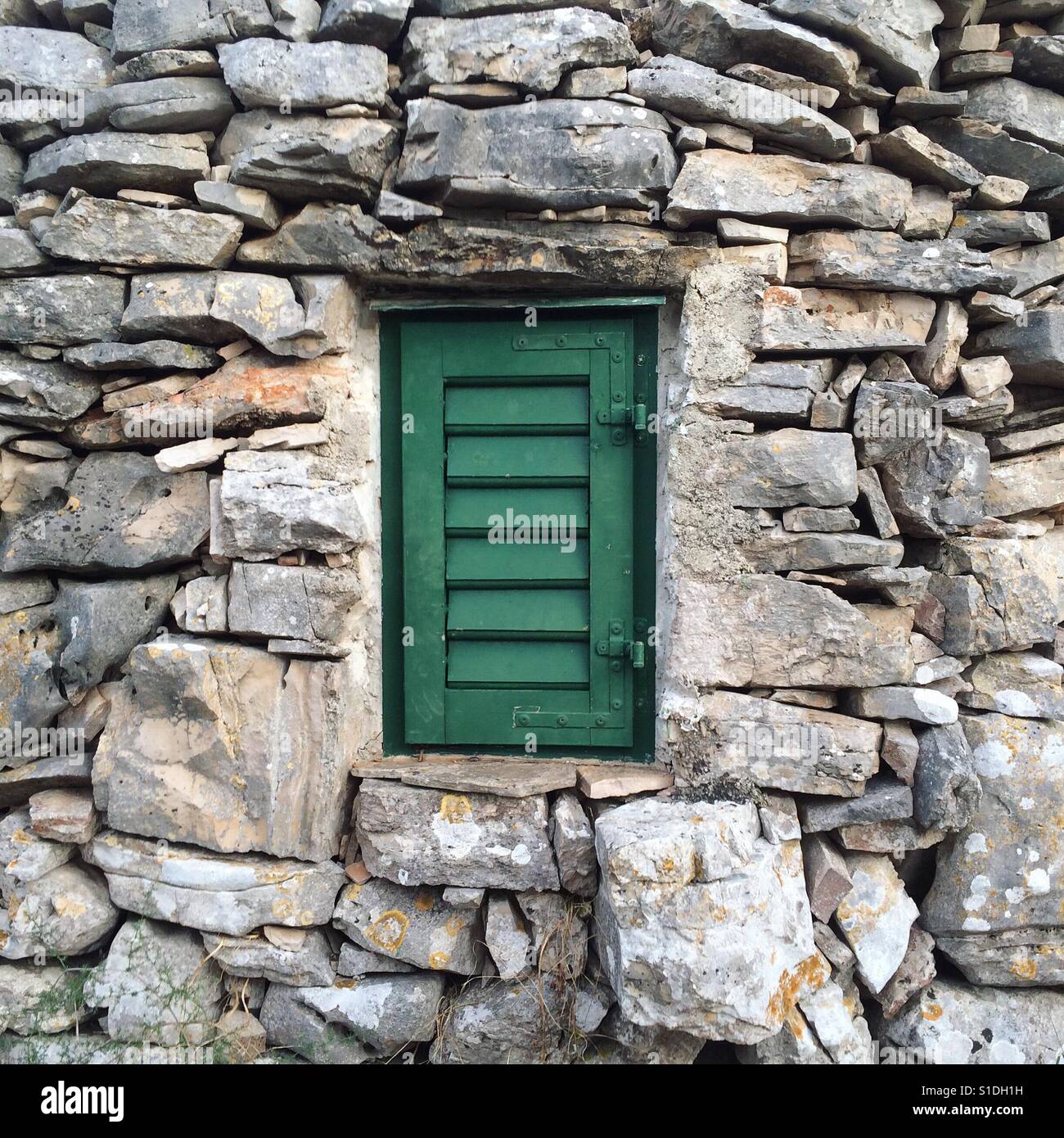 Green window in a stone wall Stock Photo - Alamy