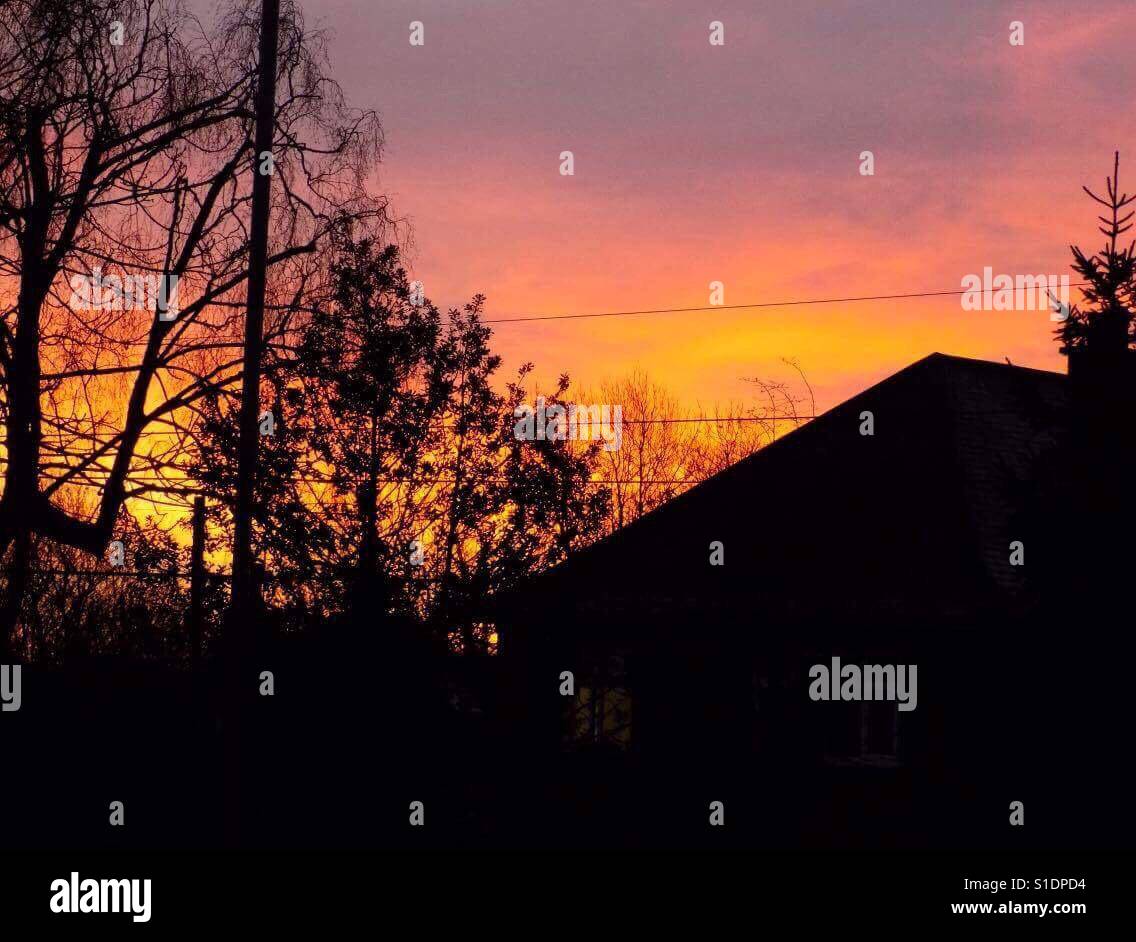 Sunset over house Stock Photo - Alamy