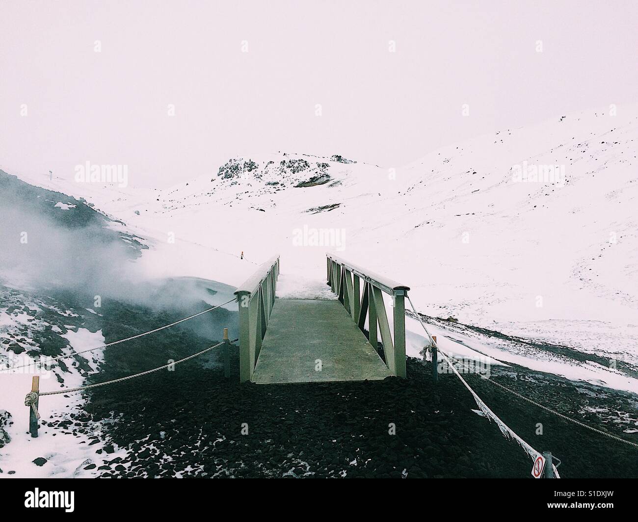 Iceland. A bridge across a 100-degree water coming from the volcano ...