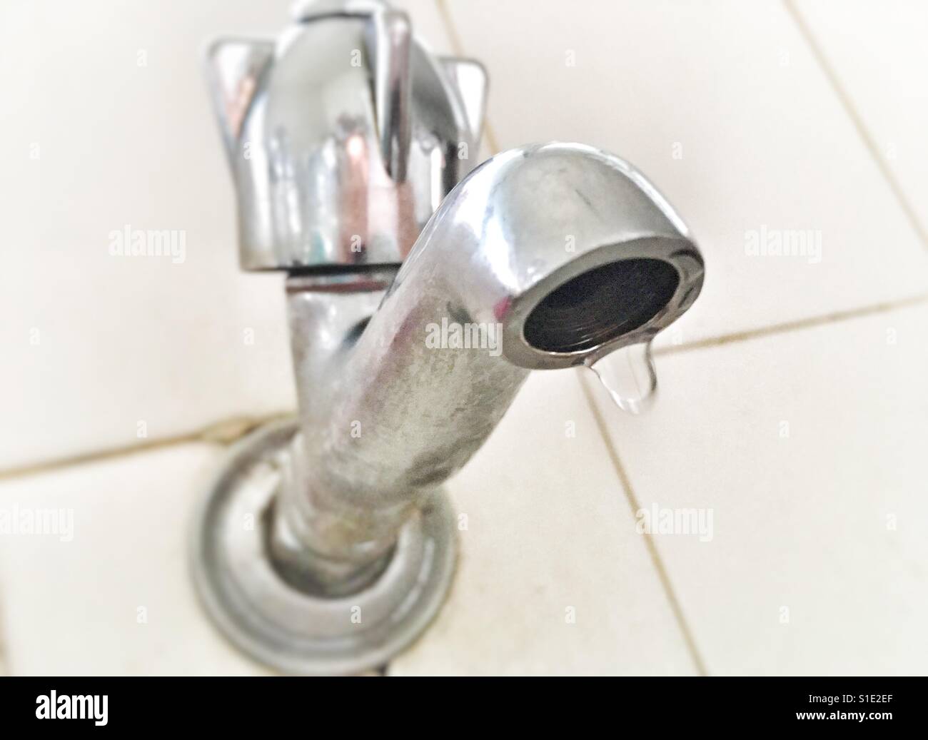 Water drop falling from a tap Stock Photo - Alamy