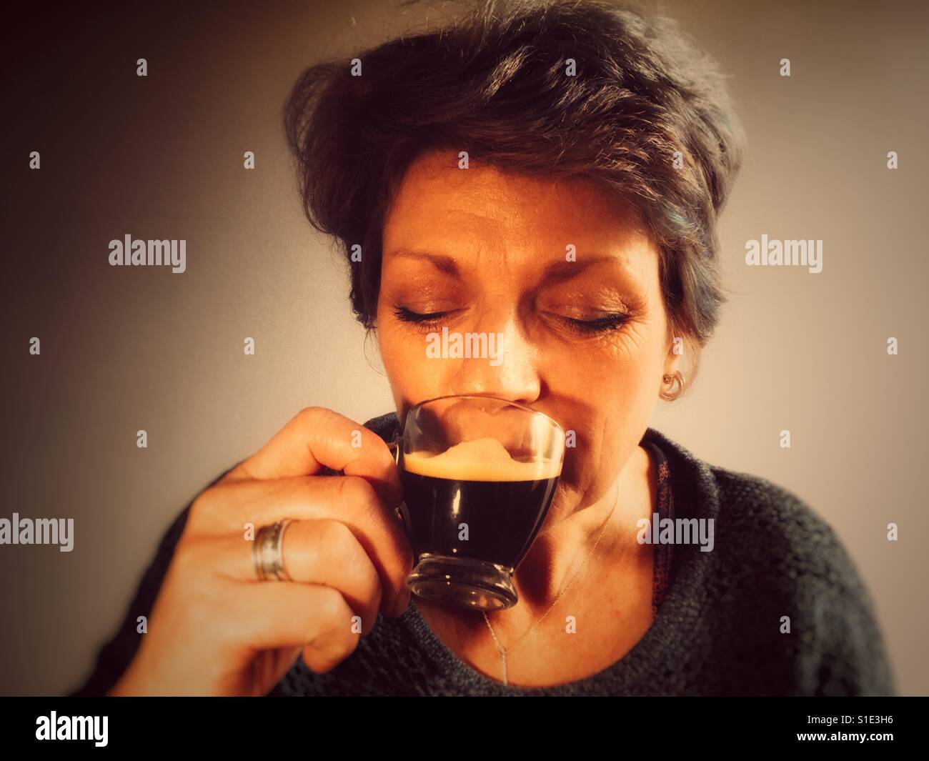 Woman drinking espresso coffee Stock Photo - Alamy