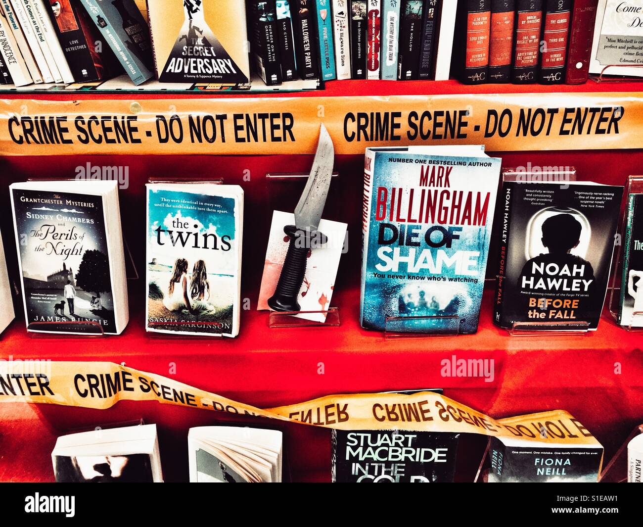 Crime novels in bookshop window display Stock Photo - Alamy