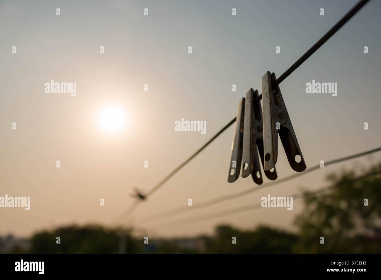 The metal clips to hold on the clothes Stock Photo - Alamy