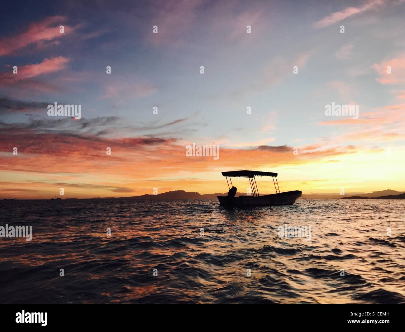 A sunset over Nadi island from Tavarua. Tavarua Island, Fiji Stock ...
