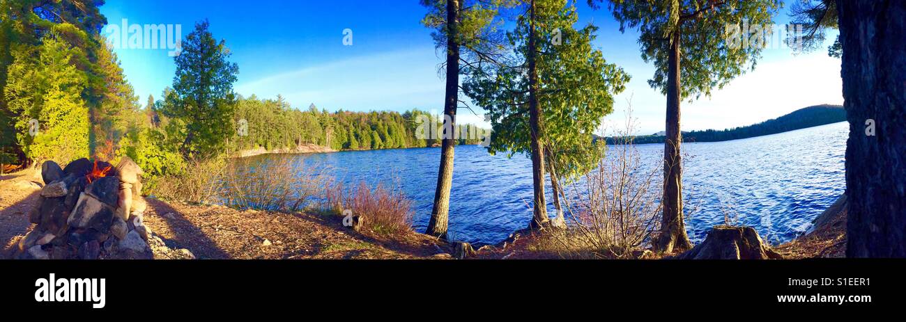 Spring Campfire By Island Lake Panorama Stock Photo - Alamy