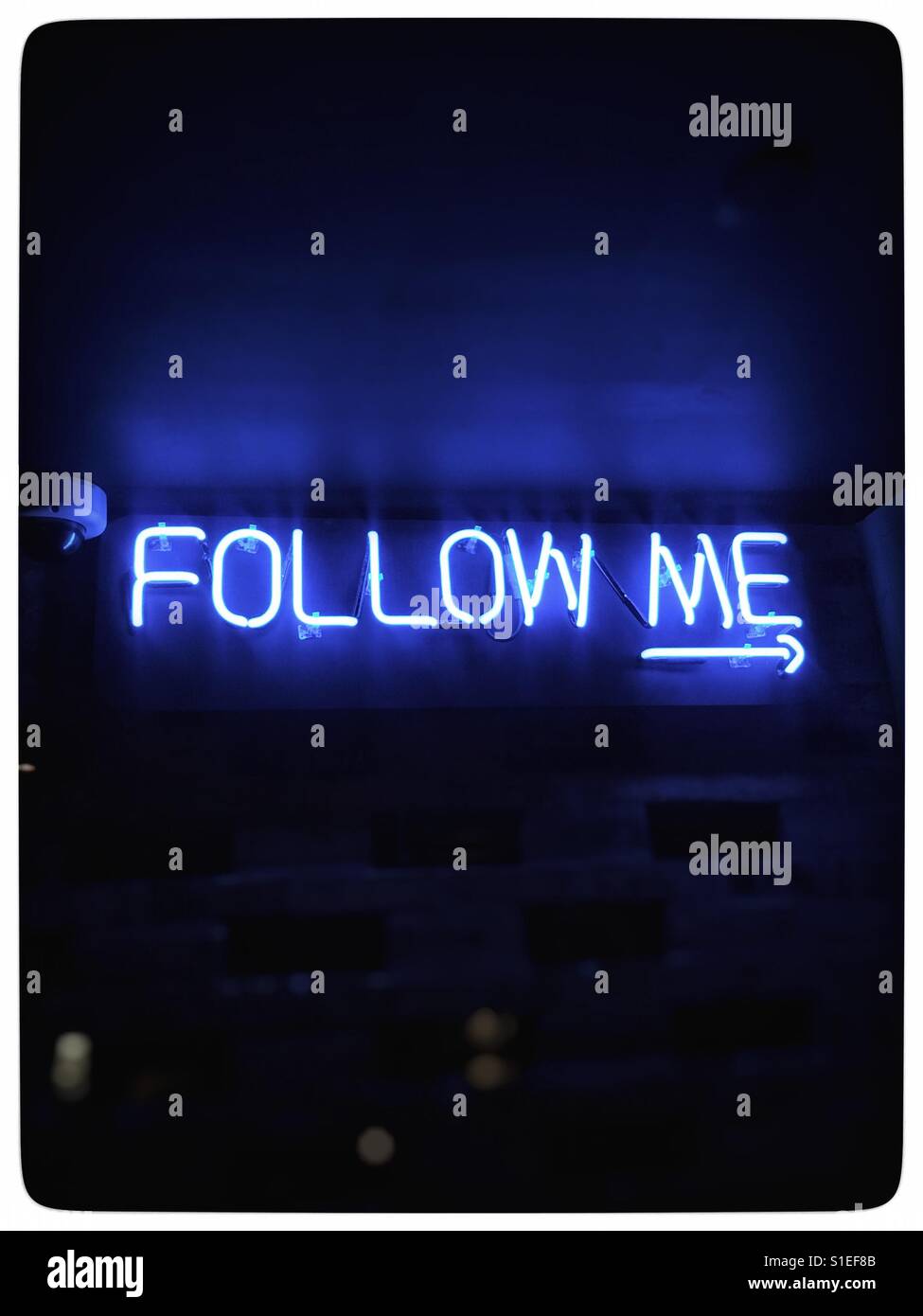 Follow Me blue neon sign Stock Photo - Alamy