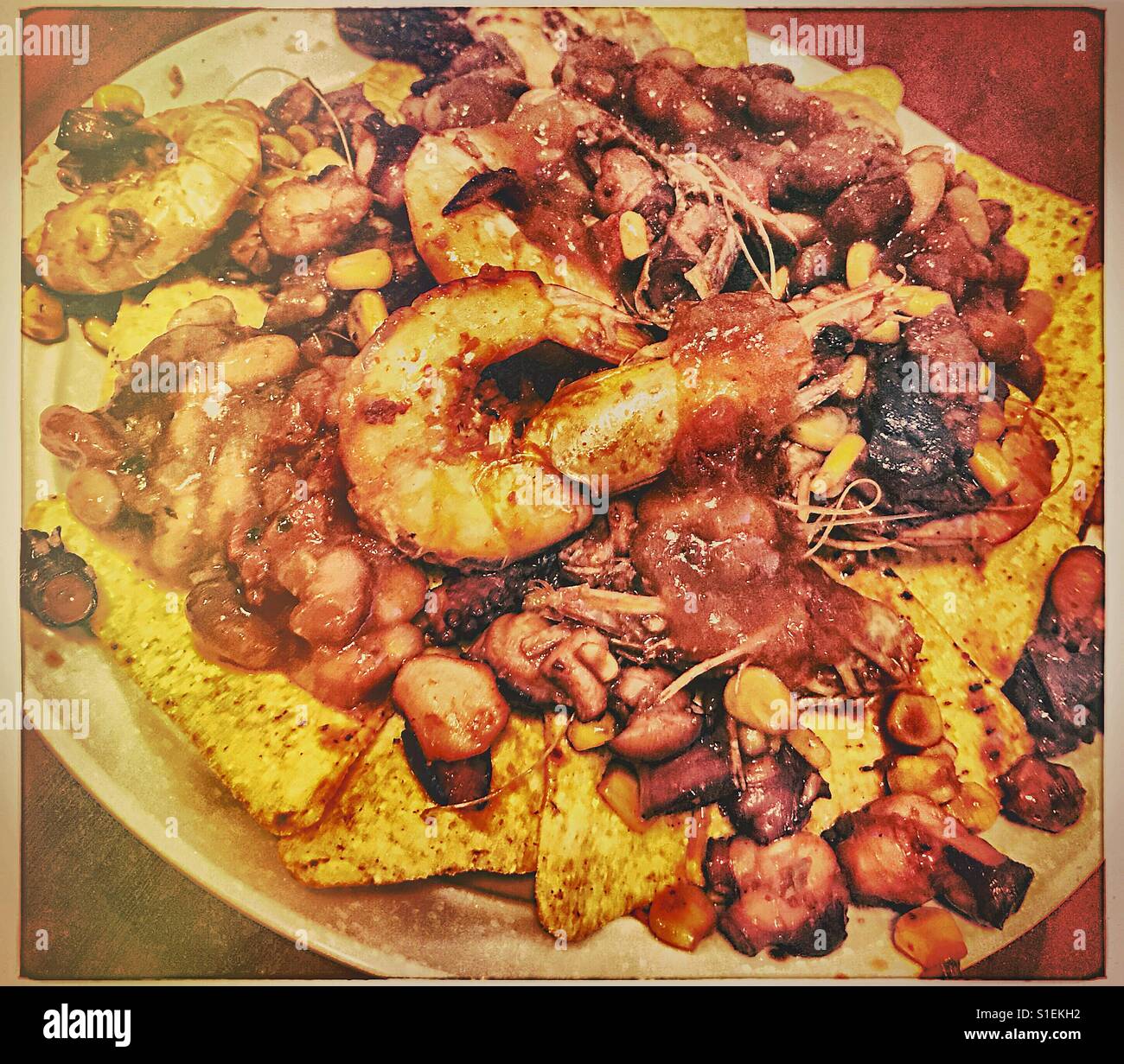 Seafood fusion nachos Stock Photo - Alamy