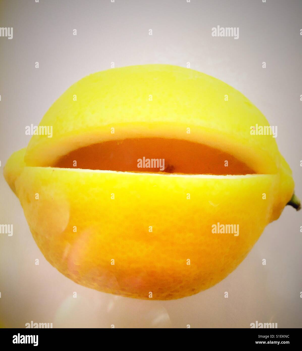 Whole fresh lemon with a slice cut out Stock Photo - Alamy
