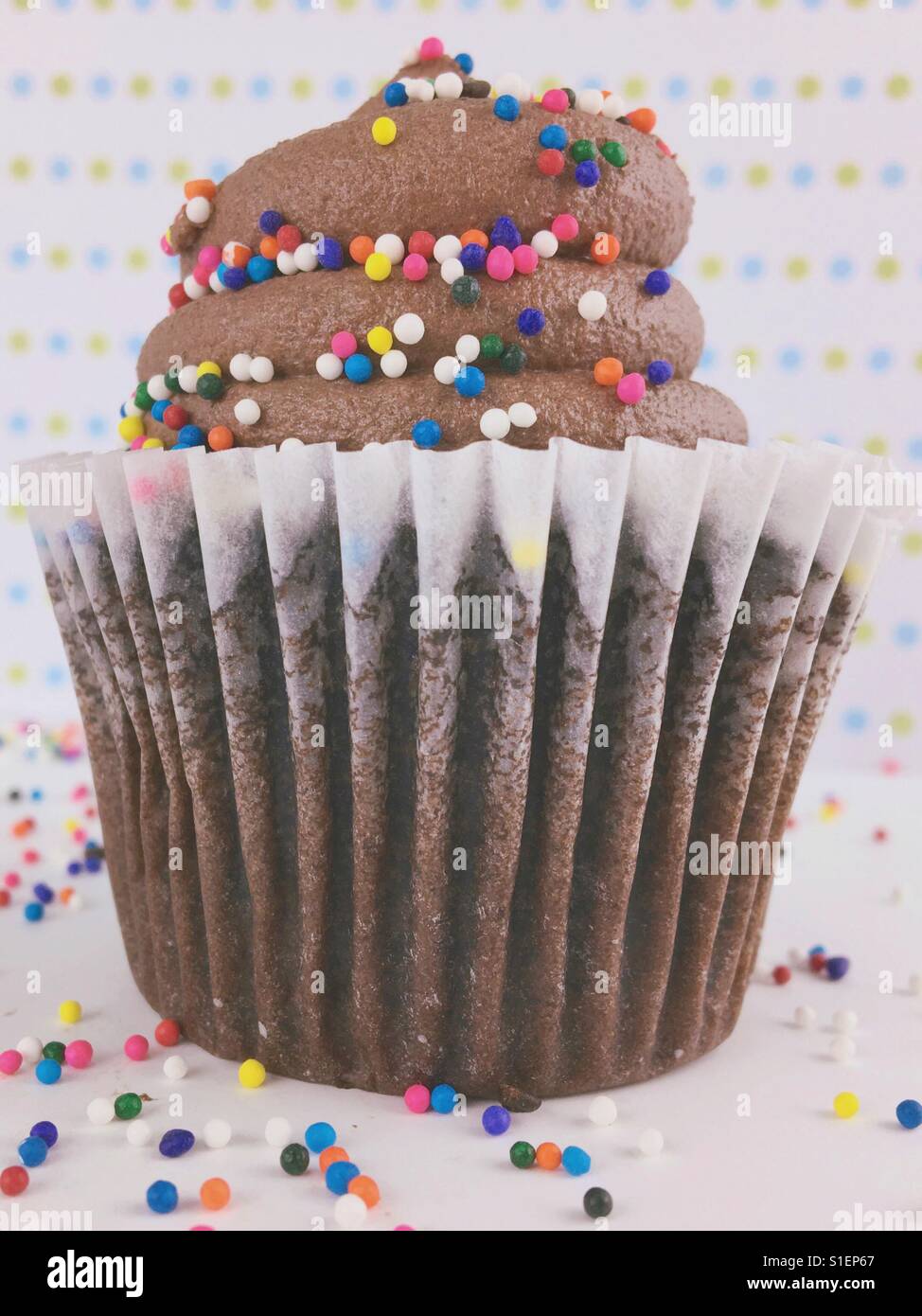 Chocolate cupcake and sprinkles Stock Photo - Alamy