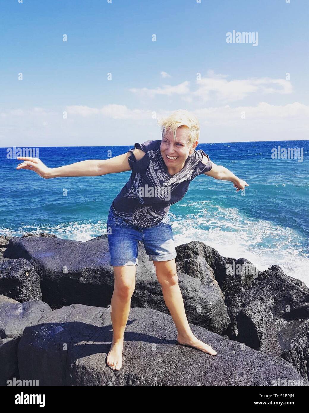 Woman balancing on rocks Stock Photo - Alamy