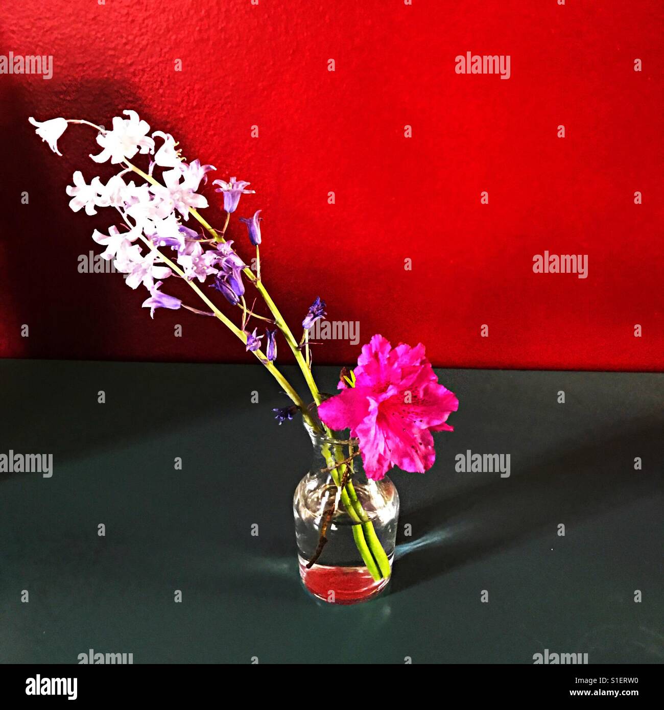 Table with flowers and mini vase Stock Photo - Alamy